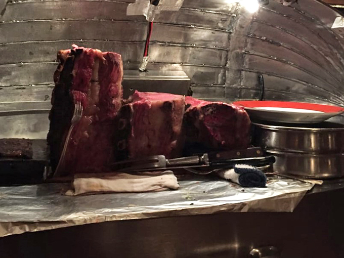 The mothership has landed! This gleaming cart, loaded with prime rib, is like Santa's sleigh for carnivores. Christmas comes with every slice!