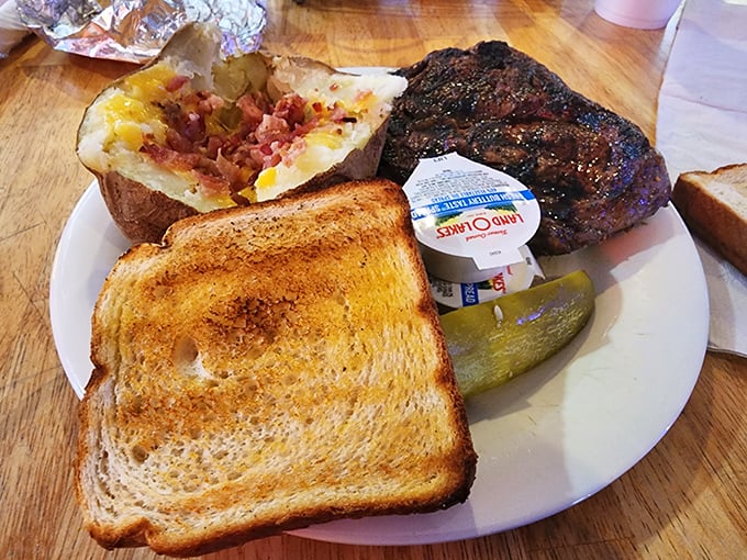 A plate that screams "America!" Steak, potato, and toast – the holy trinity of comfort food.