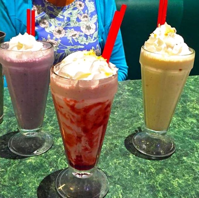The holy trinity of milkshakes! Chocolate, strawberry, and vanilla stand at attention, ready to transport you back to simpler times when calories were just a twinkle in Richard Simmons' eye.
