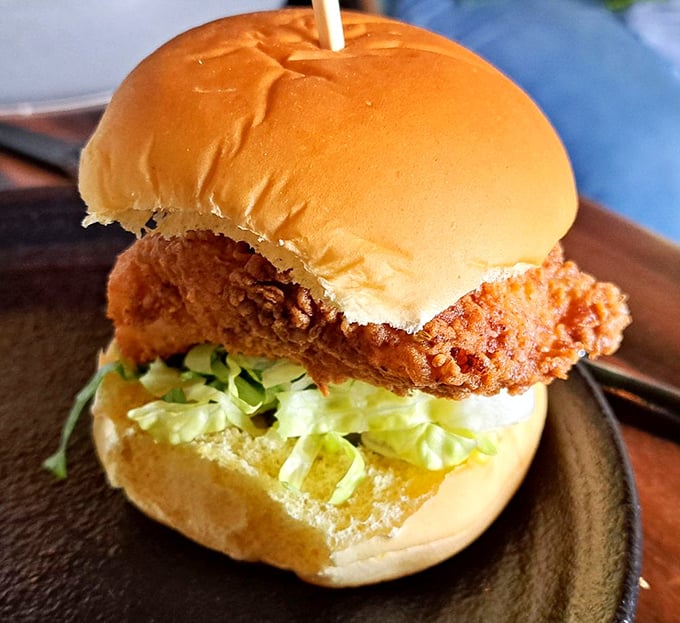 This isn't just a sandwich; it's a tower of power! Crispy chicken, fresh lettuce, and a bun so soft it could moonlight as a pillow.