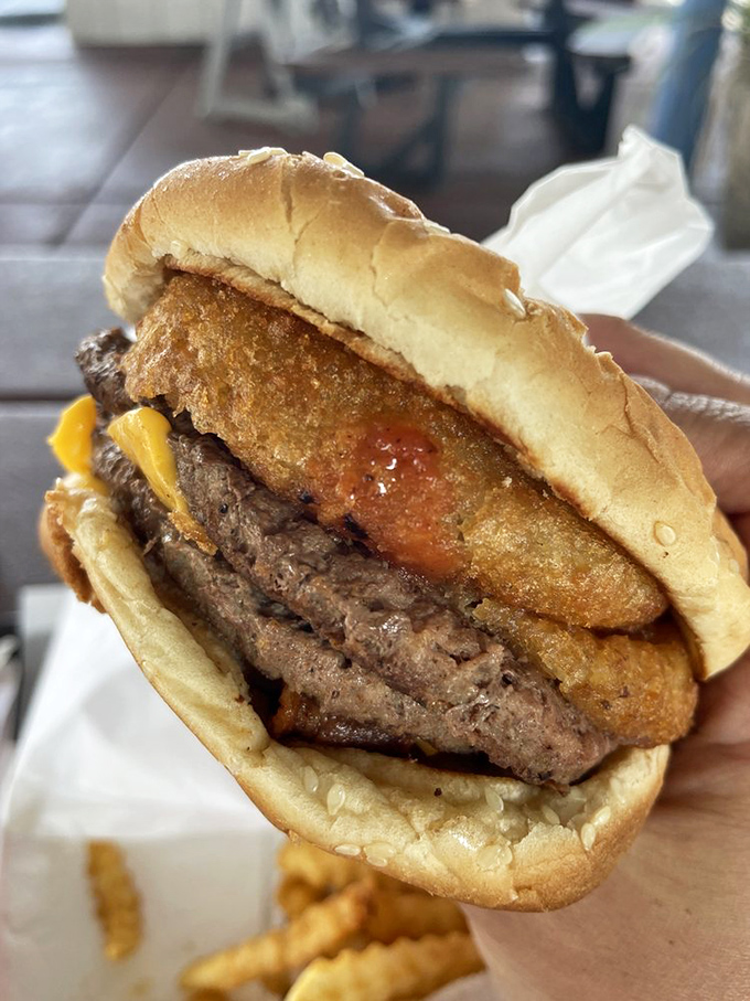 Behold the burger that launched a thousand cravings! This bad boy is stacked higher than your grandpa's stories about walking to school uphill both ways.