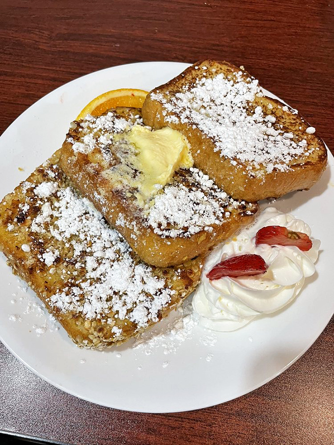 French toast that puts the "ooh la la" in breakfast! Dusted with powdered sugar and topped with a pat of butter, it's like your childhood favorite got a gourmet makeover.