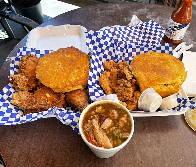 "Behold, the holy trinity of Southern comfort: fried chicken, cornbread, and gumbo. It's like a warm hug for your taste buds!"