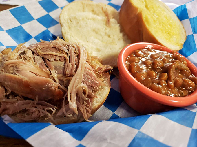 The pulled pork sandwich: where bread meets meat in perfect harmony. It's like a hug for your taste buds, with a side of comfort food nostalgia.