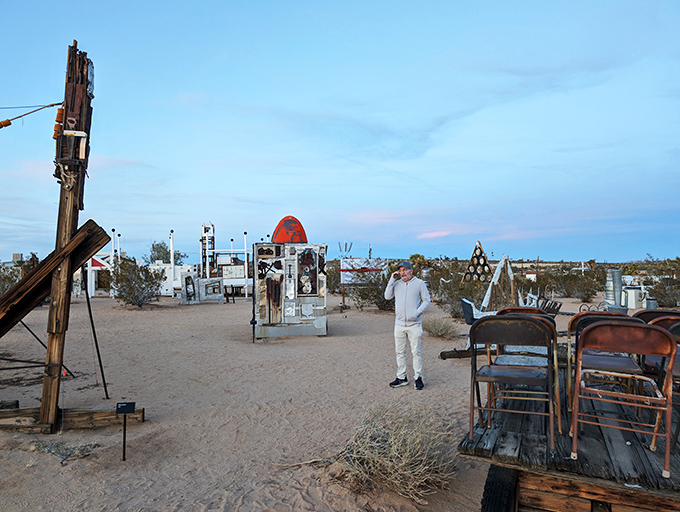 Is this real life, or just fantasy? A visitor ponders existence amidst a sea of surreal sculptures and desert dreams.