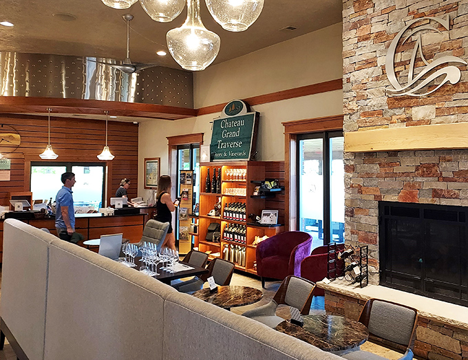 Cozy stone fireplace meets sleek tasting bar. It's the perfect blend of rustic charm and modern flair, just like a well-aged wine.