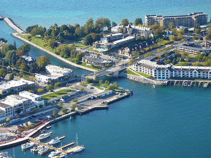 Charlevoix's picturesque harbor: Where boats slumber under a blanket of snow, and the lighthouse stands sentinel over Lake Michigan's icy waters.