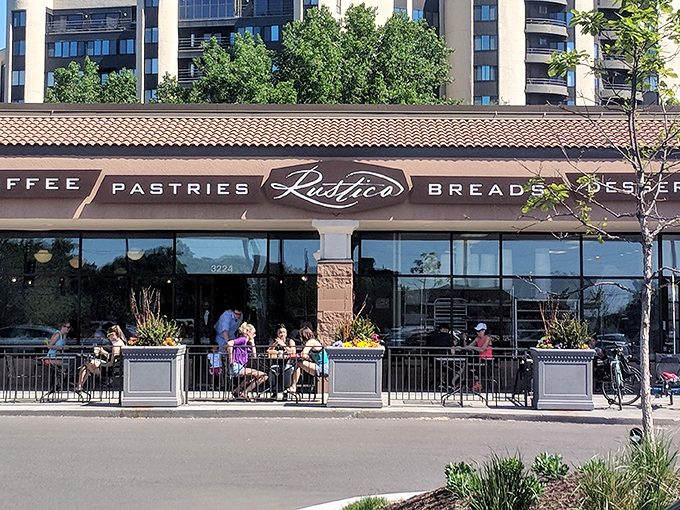 Rustica's bustling patio: Where coffee meets croissant in a sun-soaked setting. It's like a Parisian cafe, but with Minnesota nice!