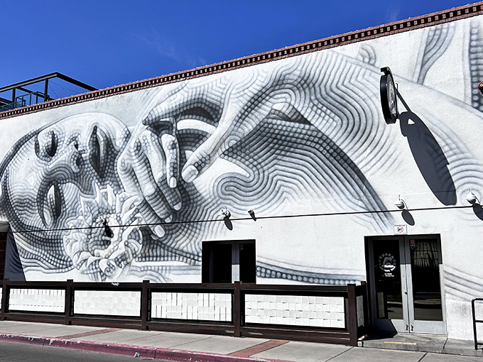 Art attack at Cobra Tucson! The mesmerizing facade transforms this arcade into a larger-than-life canvas of monochromatic wonder.
