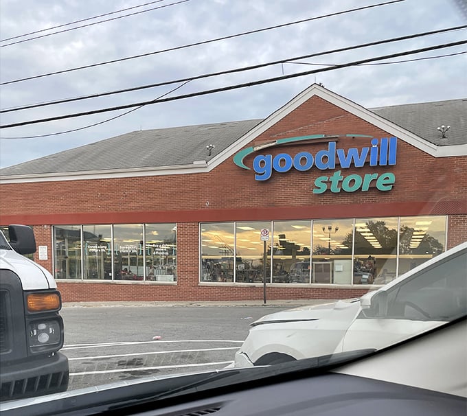 "Blue sign, green savings. Goodwill's brick facade hides a world of wallet-friendly wonders waiting to be discovered."