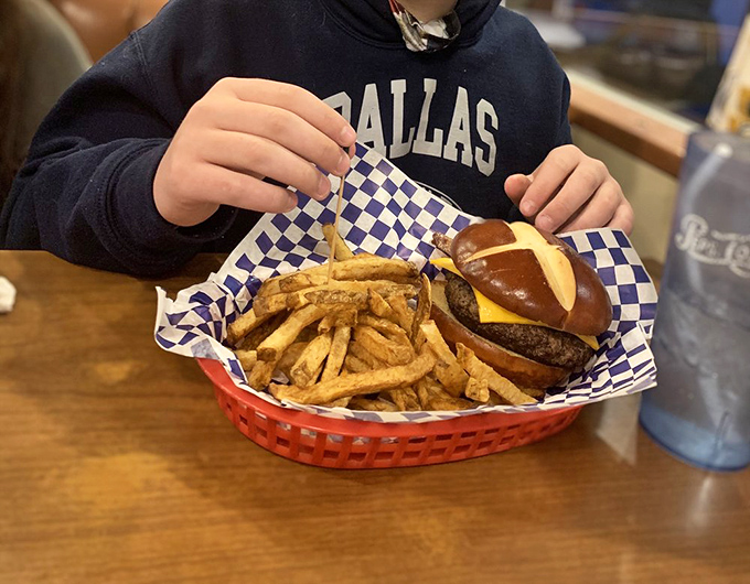 Burger bliss achieved! This bad boy is stacked higher than a Jenga tower and twice as likely to make you say "Oh yeah!"