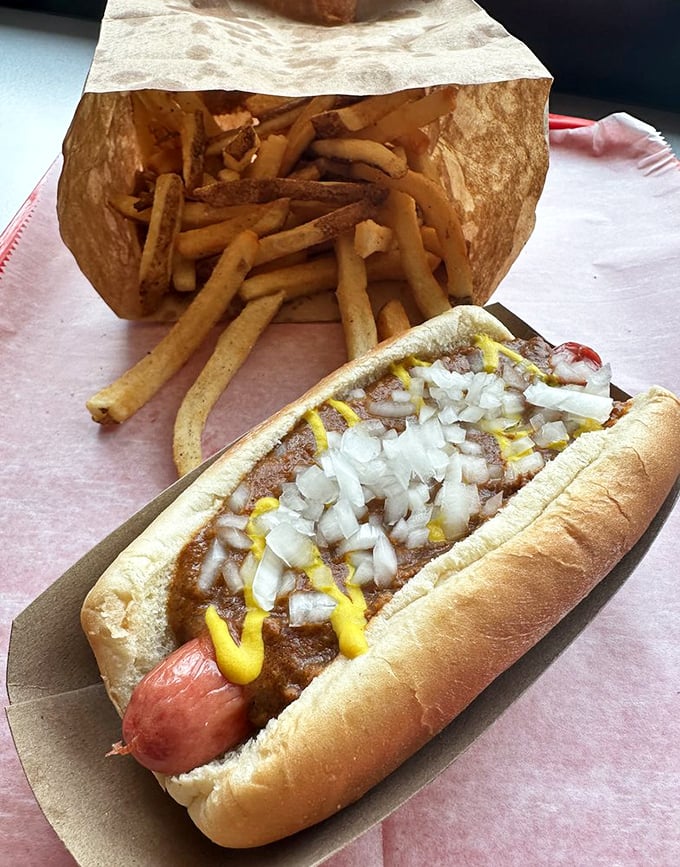 Detroit meets delicious! This Coney dog is dressed to impress, flanked by crispy fries that are clearly ready for their close-up.