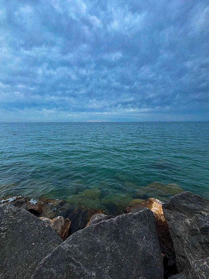 Rock solid relaxation! These lakeside stones offer front-row seats to nature's greatest show - the endless dance of water and sky.