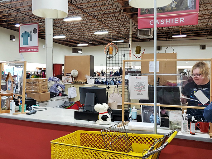 Behind protective barriers, dedicated staff members keep the checkout process smooth and friendly.