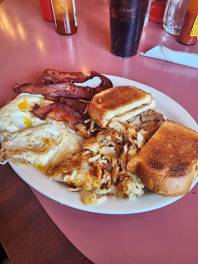 The holy trinity of breakfast: eggs, bacon, and hash browns. It's like a warm, edible hug from your favorite diner.