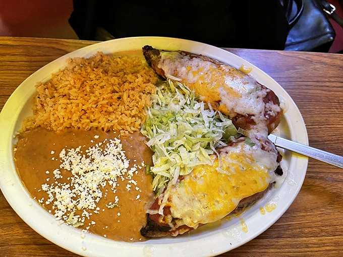 Holy mole! These chile rellenos are a flavor explosion waiting to happen, nestled next to a bed of rice that's anything but plain.