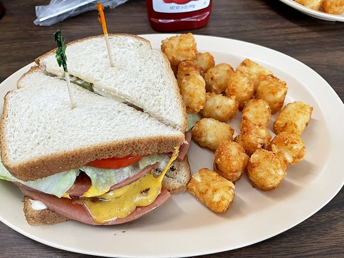 The sandwich that'll make you say "That'll do, pig!" A hearty helping of fried bologna, nestled between bread slices, with crispy tater tots standing guard. Childhood nostalgia on a plate!