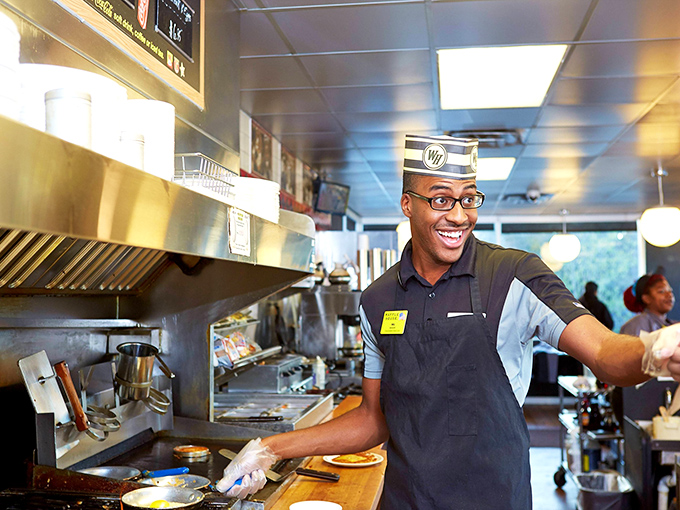 Smile and say "cheese omelet"! This cheerful cook embodies the spirit of Waffle House - serving up happiness 24/7.