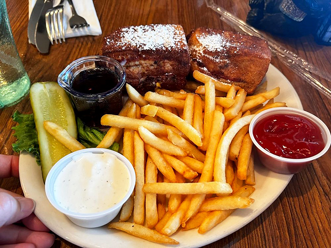 Who said you can't have it all? This plate is a carb lover's paradise, featuring golden fries and what looks like the world's most indulgent French toast.