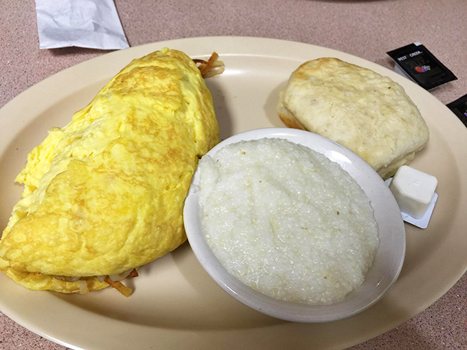 Eggs-actly what the doctor ordered! This fluffy omelet and creamy grits combo is like a warm, cheesy hug for your stomach.