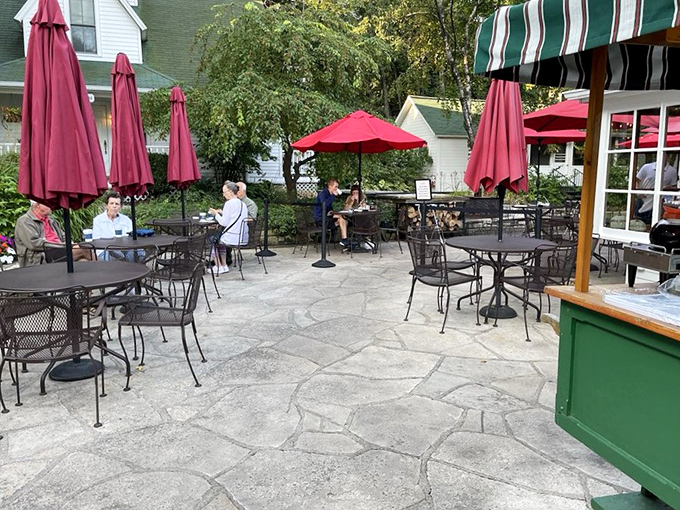 Al fresco bliss: Red umbrellas dot the patio, offering the perfect perch for people-watching and savoring Door County's finest flavors.