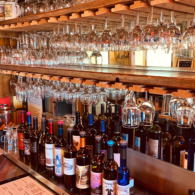 Glasses half full of possibility! This rustic bar is where wine dreams come true, one sip at a time. Let the tasting adventure begin!