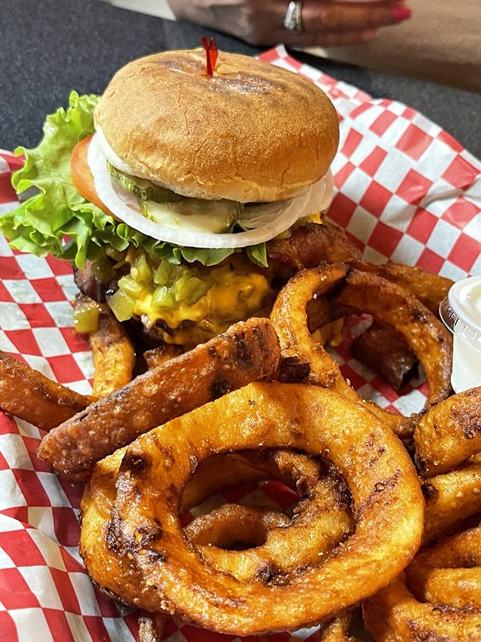Hold onto your napkins, folks! This burger's piled higher than a Midwest snowdrift, with a side of crispy onion rings that'll make you weak in the knees.