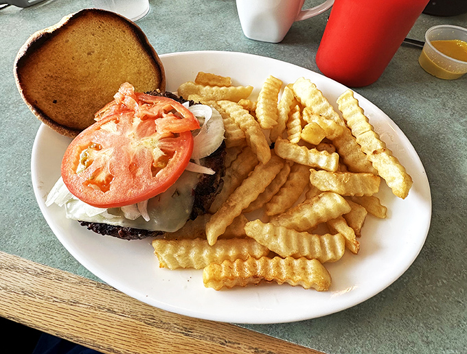 Who says burgers are just for lunch? This hearty sandwich proves that breakfast can pack a punch. Crispy fries included for good measure.