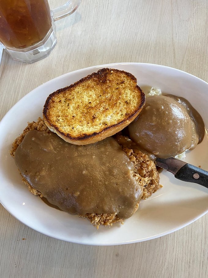 This isn't just any chicken fried steak, folks. It's a crispy, gravy-smothered masterpiece that could make a lumberjack swoon.
