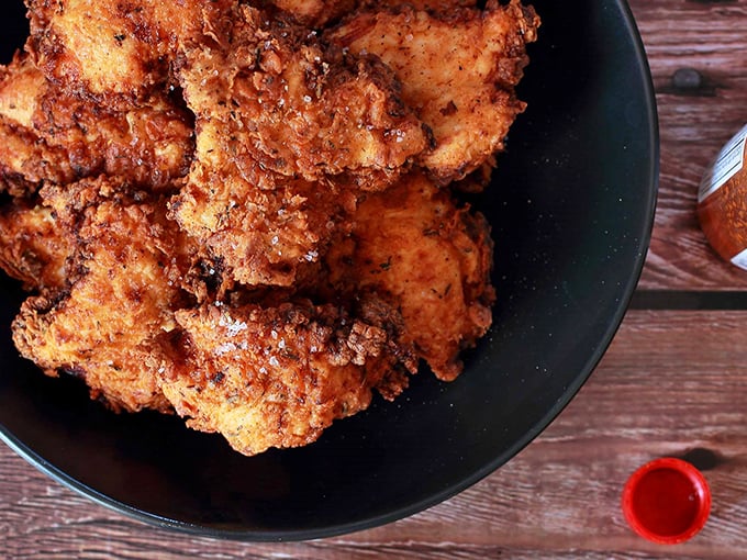 Fried chicken so golden, it puts Fort Knox to shame. Each piece is a crispy treasure chest of juicy, flavorful goodness.