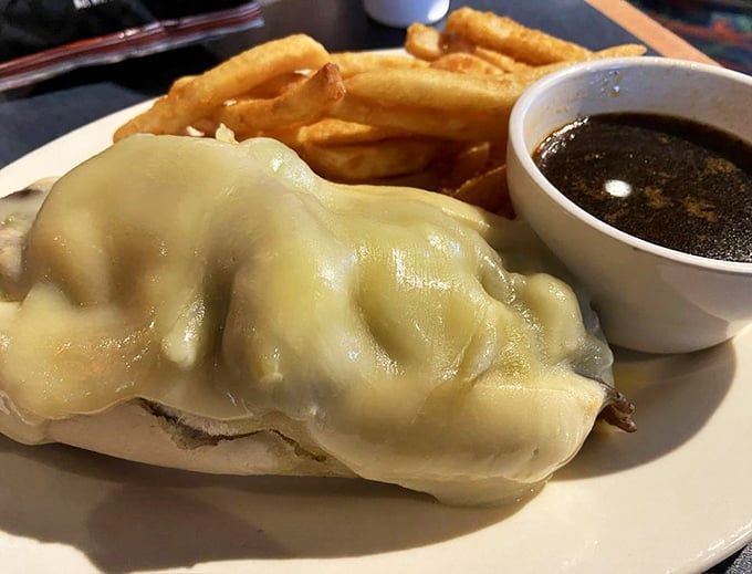 Behold the French Dip, the Parisian cousin of the Philly Cheesesteak! It's not swimming, it's taking a flavor bath in that rich, savory au jus.