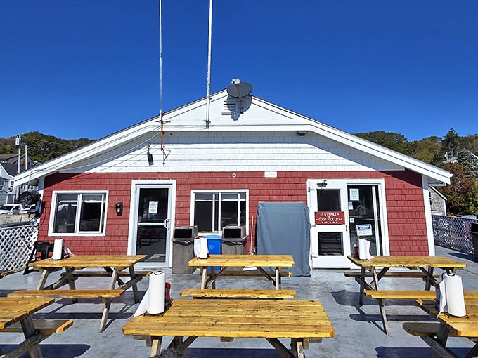 Shaw's wooden deck extends over the water like a ship's bow, offering diners a captain's view of New Harbor's maritime ballet.