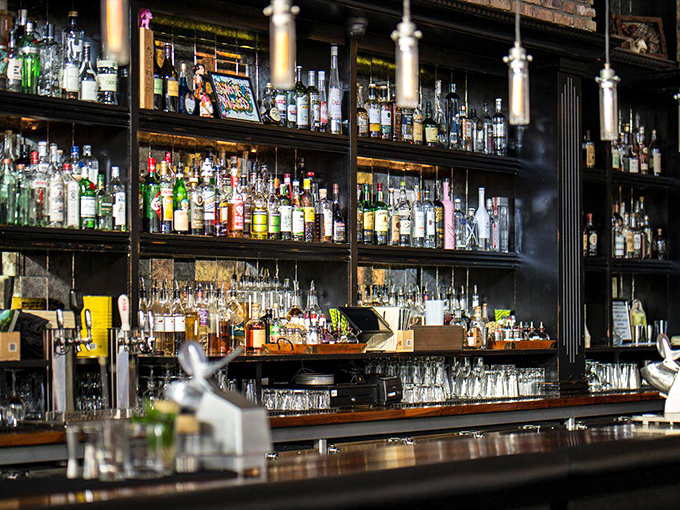 From Prohibition HQ to cocktail central! This bar's gleaming shelves and moody lighting set the stage for libation liberation.
