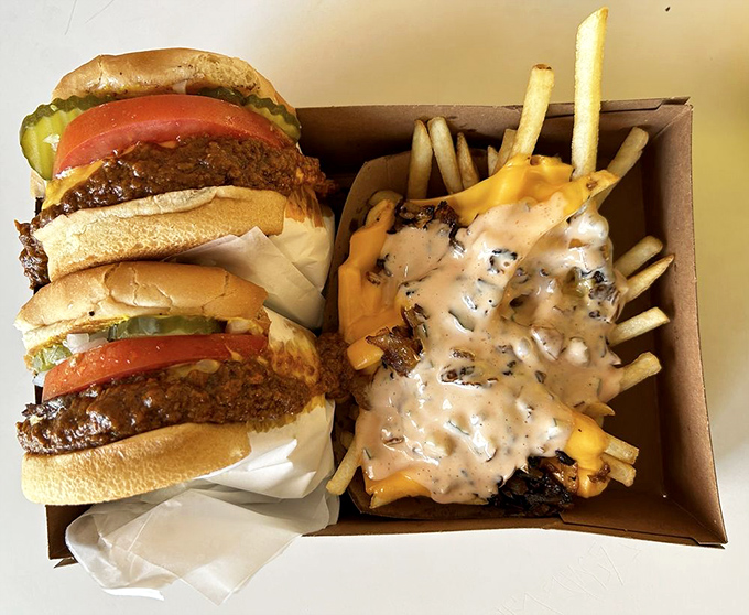 Chili today, hot tamale! This burger's got more layers than a telenovela and twice the drama. Napkins required, bibs recommended.