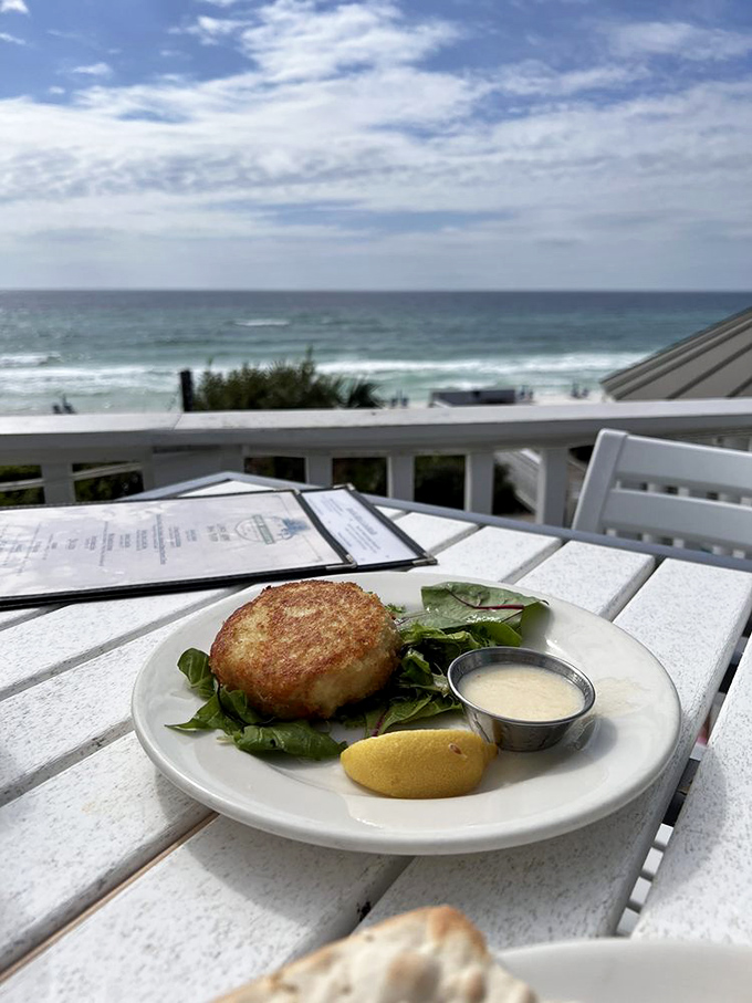 Ocean views and crab cake hues! This golden disc of deliciousness is your ticket to seafood nirvana. Don't forget to savor that zesty sauce!