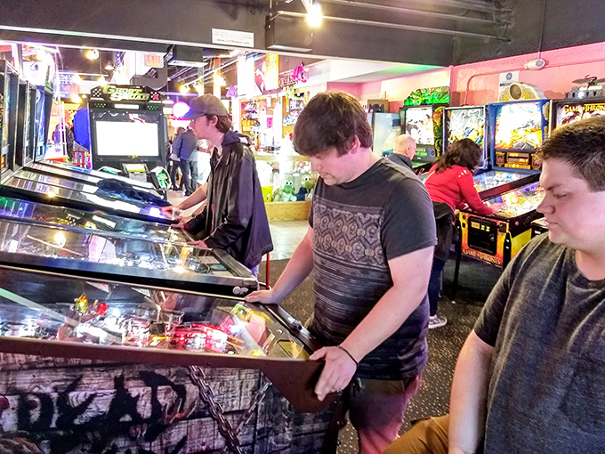 Pinball wizards in training! These folks are more focused than a cat watching a laser pointer. Game on, indeed!