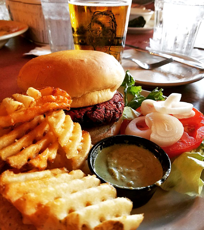 The Earth Burger lands on your plate with a side of crispy waffle fries. It's a match made in comfort food heaven.