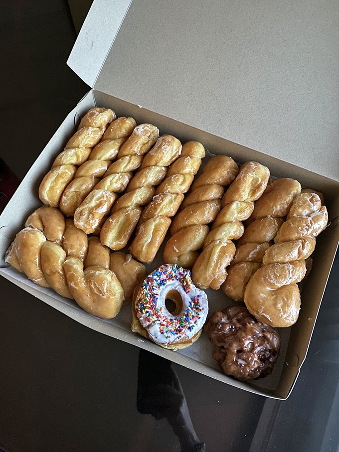 Spiral into sweetness! These glazed donuts are coiled like delicious little cinnamon rolls that forgot to put on their cinnamon suits.