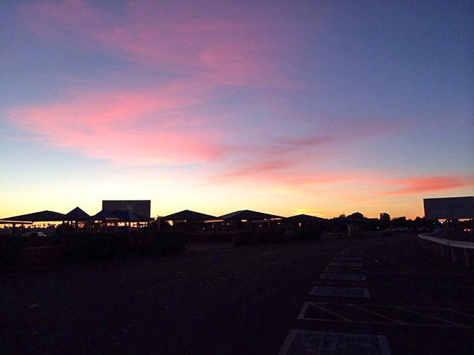 Nature's preview show begins as the sun takes its final bow. The drive-in transforms into a canvas of warm hues and anticipation.