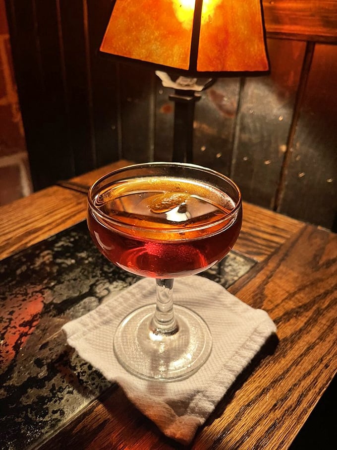 Holy smokes, Batman! The Revolver cocktail arrives under a glass dome, unveiling a show as intoxicating as its contents.