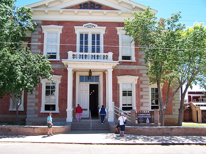 The stately Tombstone Courthouse watches over the town like a Victorian grande dame, her red brick facade glowing in the Arizona sun.