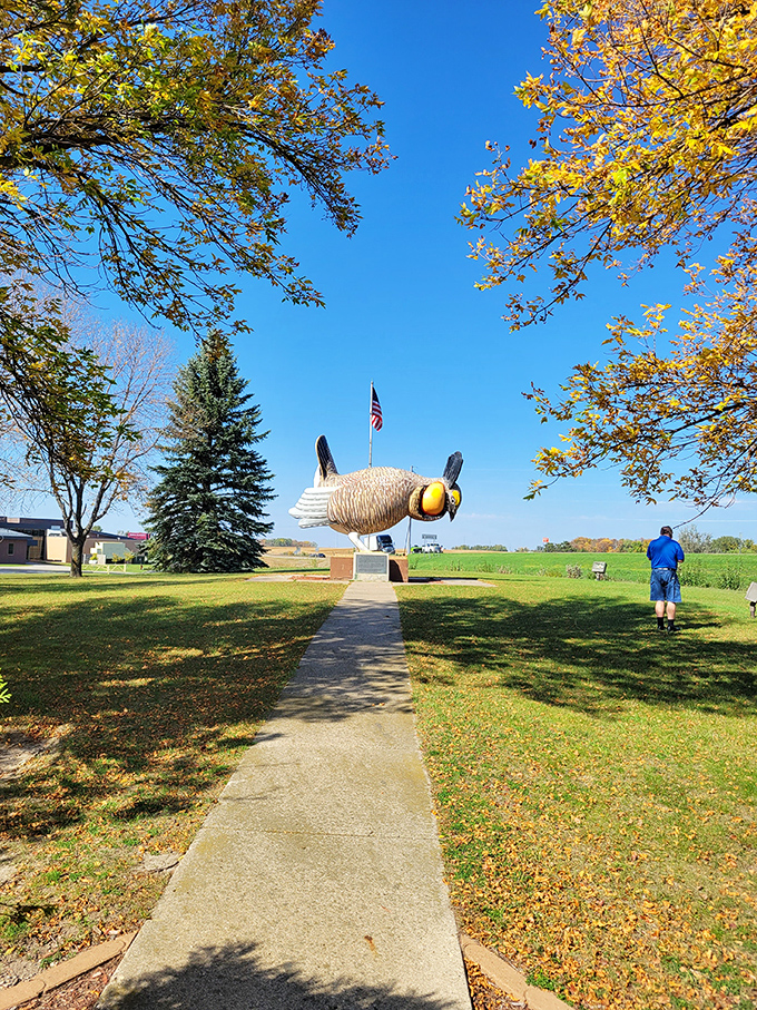 Size matters: A visitor provides scale to this mammoth bird. It's like 'Honey, I Shrunk the Kids,' but 'Honey, I Enlarged the Chicken!'
