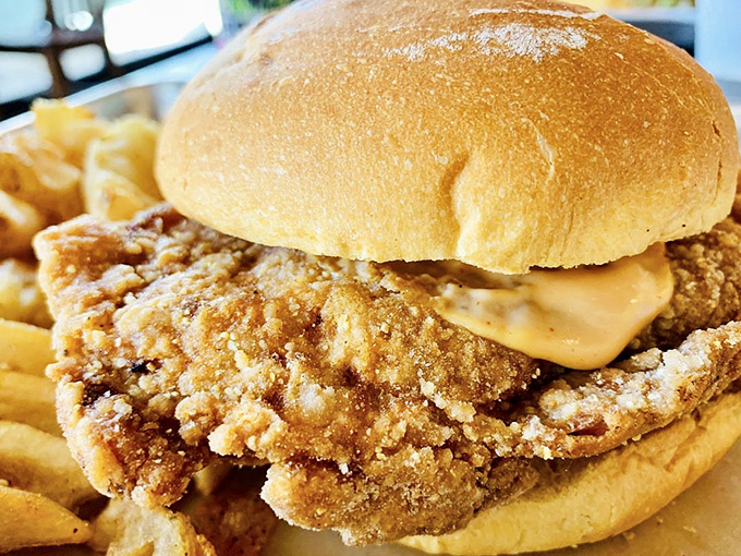 Behold, the chicken sandwich that launched a thousand cravings. One bite and you'll understand why people cross state lines for this crispy creation.