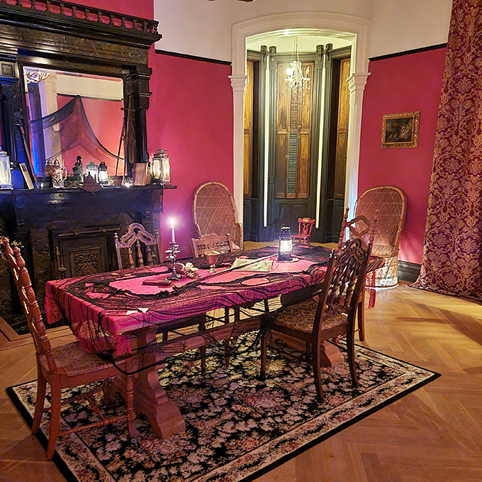 Candlelight and crimson create an atmosphere ripe for ghostly dinner parties. Who needs Netflix when you've got this atmospheric dining room?