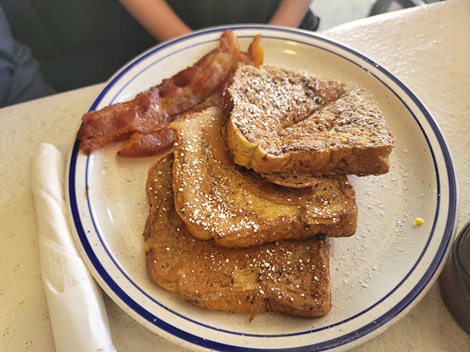 French toast that puts the "ooh-la-la" in breakfast! Golden, crispy, and paired with bacon that's crispier than a fall leaf – it's morning perfection.