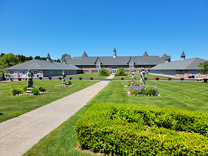 Garden goals, anyone? This meticulously landscaped path leads to a grand building that would make any green thumb turn emerald with envy.