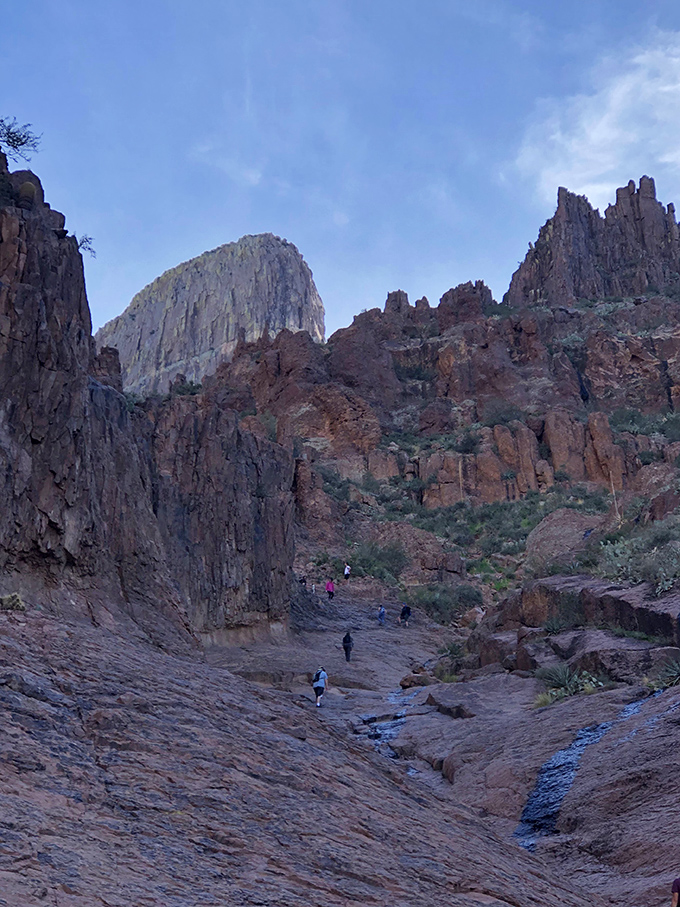 Cooling off in nature's own spa! These hikers have found the perfect spot to soak their tired feet and swap tall tales.