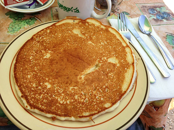 Behold, the pancake that ate Sacramento! This golden disc of deliciousness is less breakfast and more edible frisbee. Maple syrup for scale.