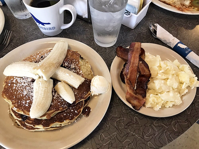 Stack attack! These pancakes are fluffier than a cloud and sweeter than your grandma's smile. Bacon for balance, because adulting.