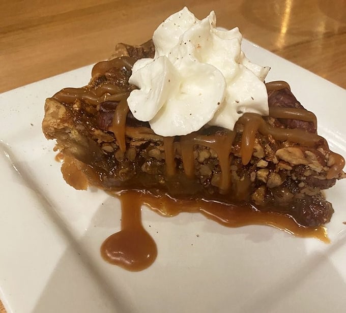 A slice of pecan paradise! This isn't just dessert; it's a religious experience topped with a dollop of pure, unadulterated joy.